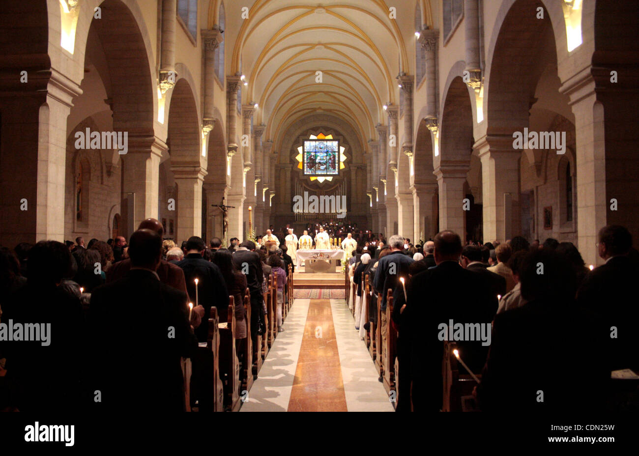 A Catholic priest lights a Paschal candle inside the Church of the ...
