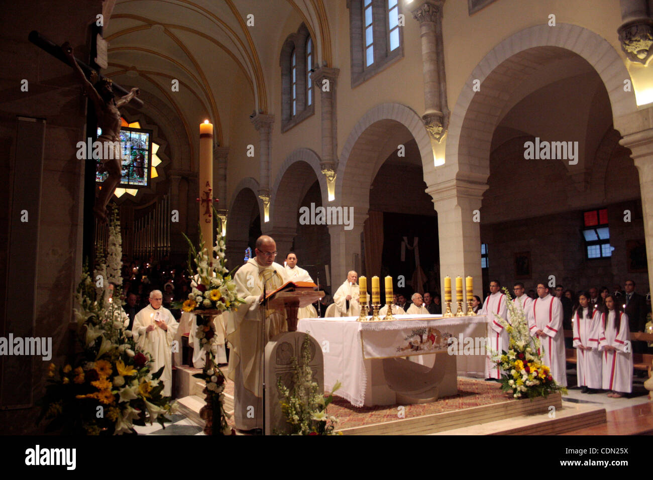 A Catholic priest lights a Paschal candle inside the Church of the ...