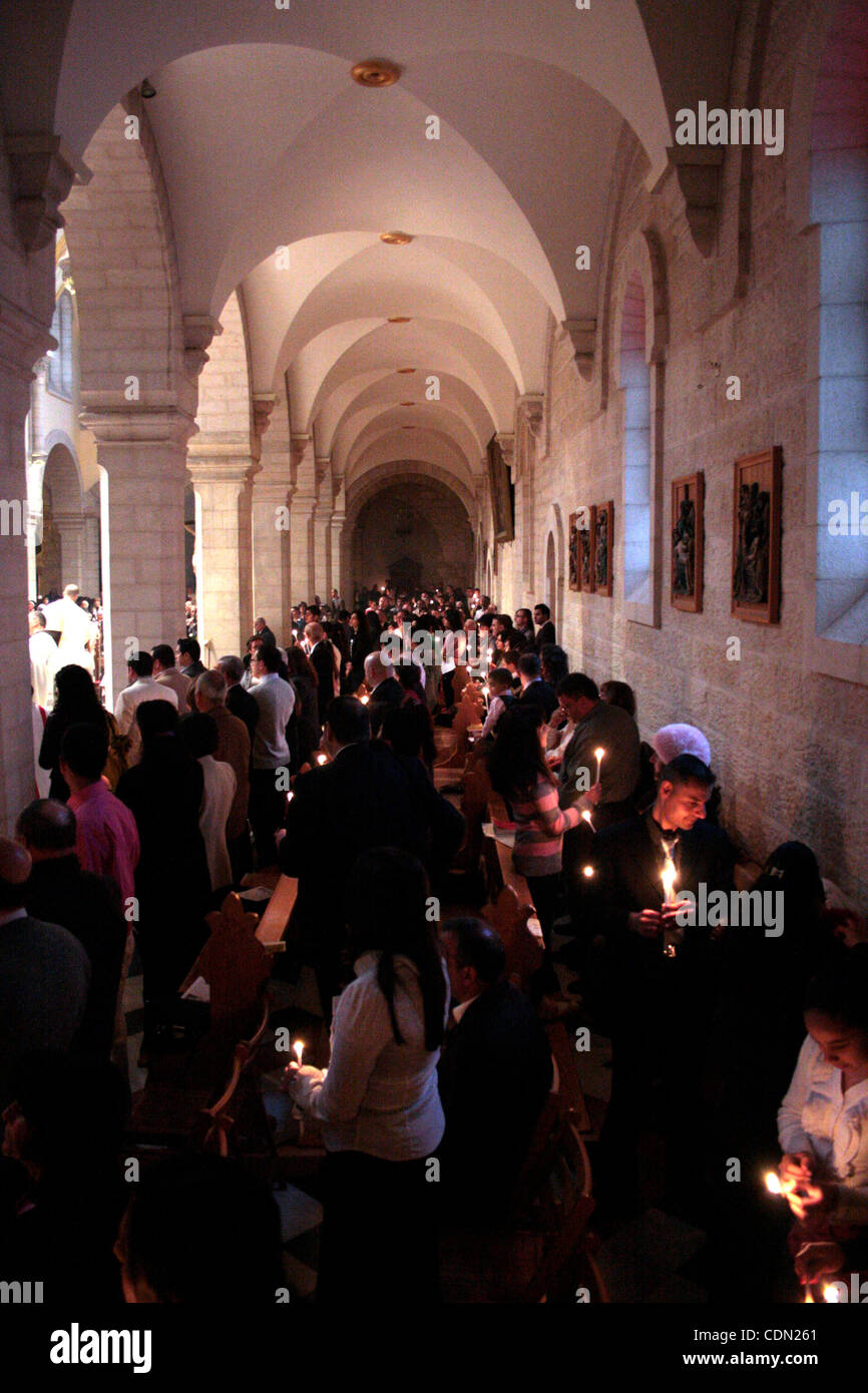 A Catholic priest lights a Paschal candle inside the Church of the ...