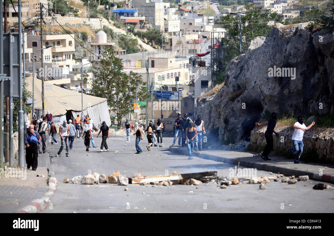 Palestinian youths hurl stones toward Israeli soldiers during clashes ...