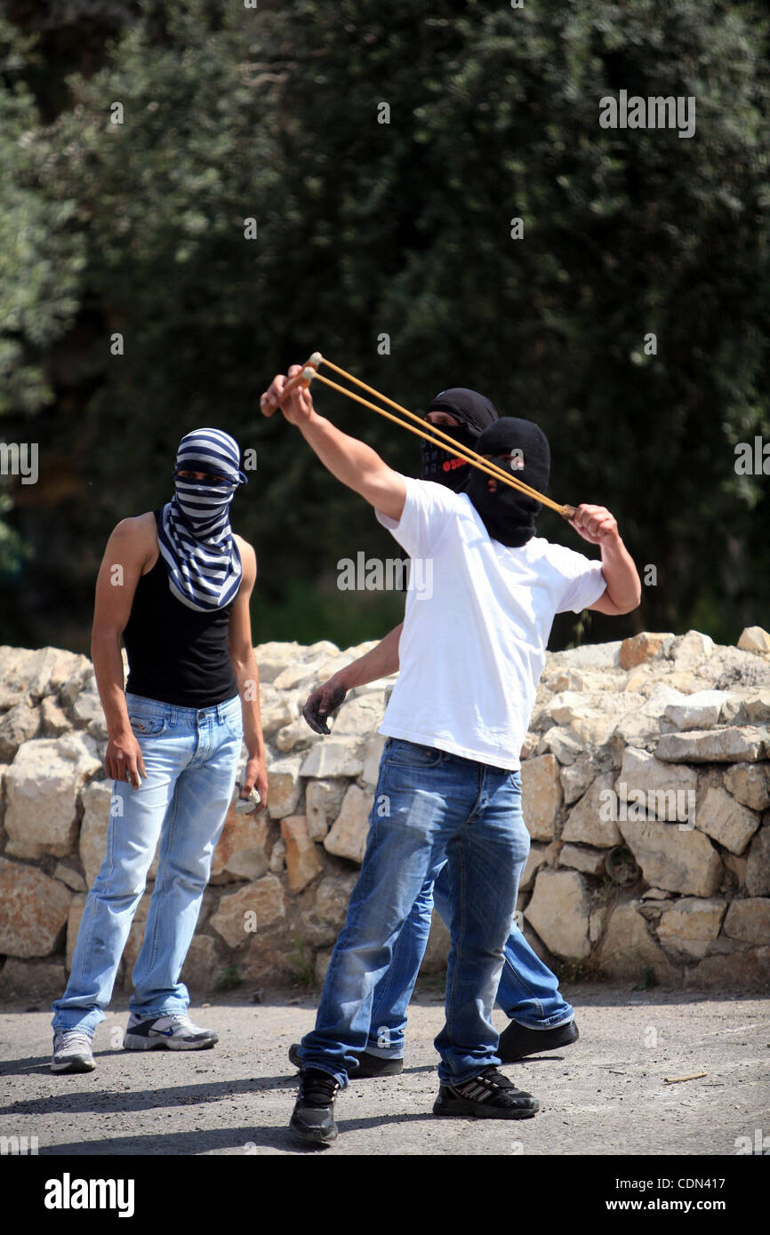 Palestinian youths hurl stones toward Israeli soldiers during clashes ...