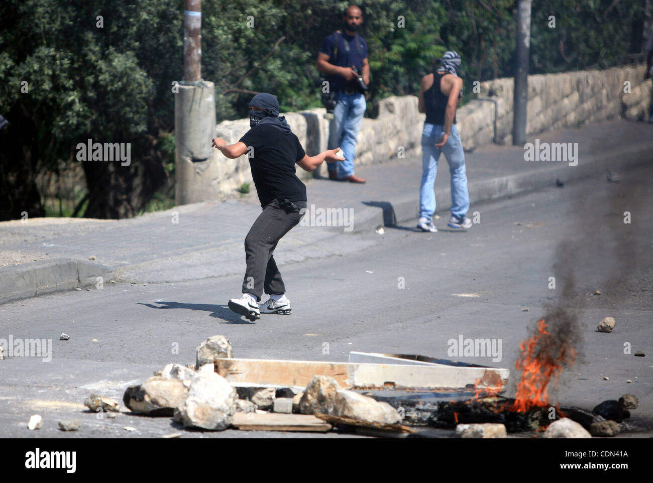 Palestinian youths hurl stones toward Israeli soldiers during clashes ...
