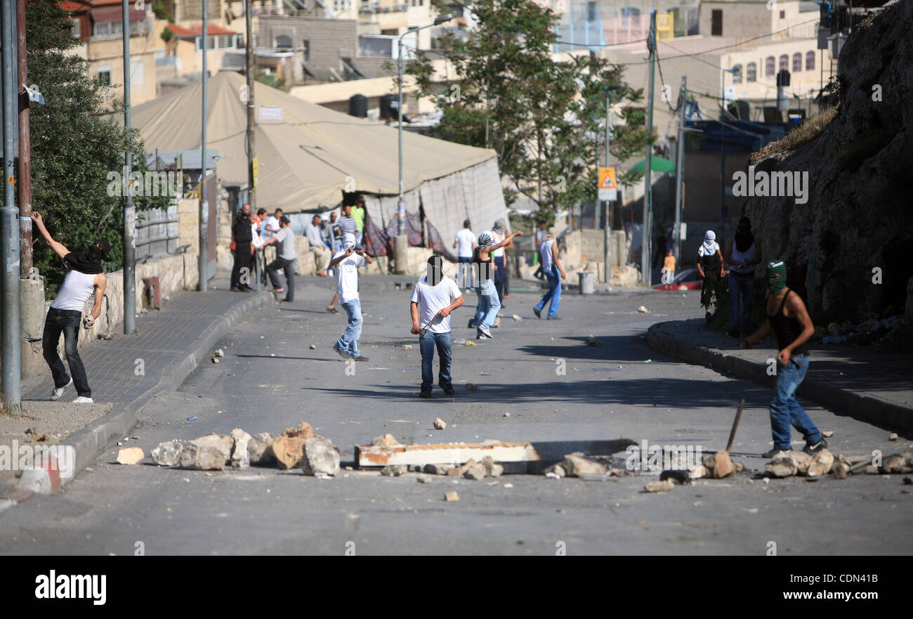 Palestinian youths hurl stones toward Israeli soldiers during clashes ...