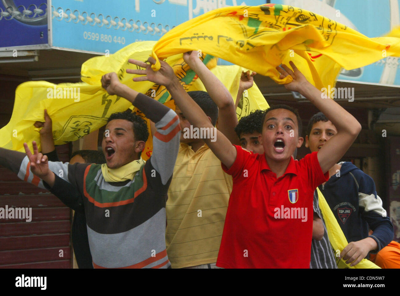 Palestinians wave with Fatah party flags during celebrations marking ...
