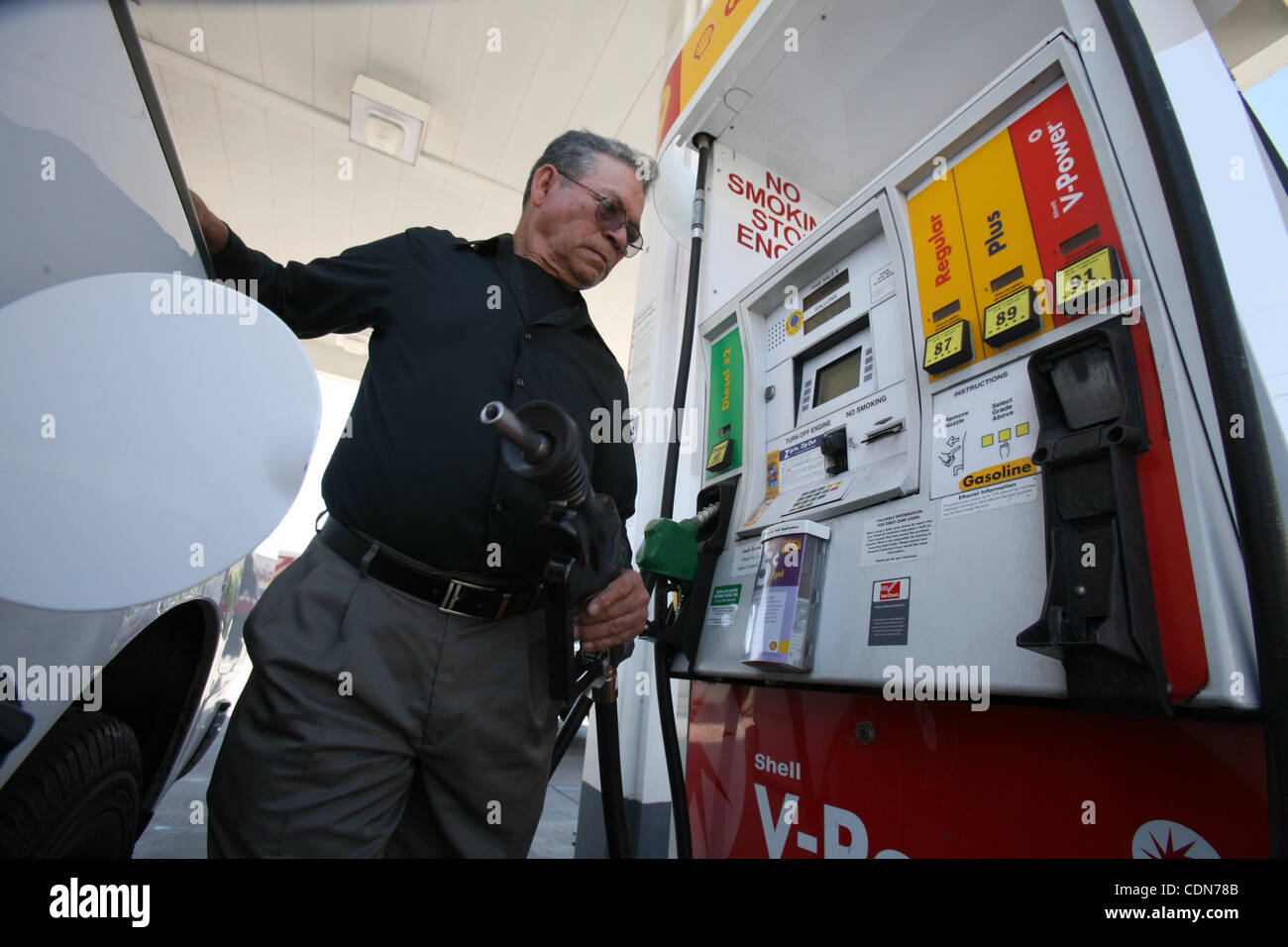 A man pumps gas at a gas station in Los Angeles.(Photo by Ringo Chiu ...