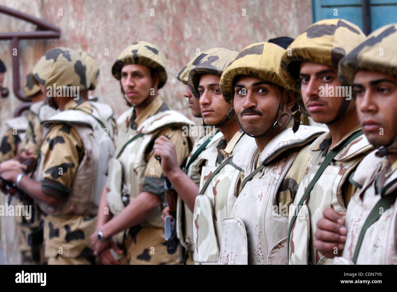 Egyptian soldiers stand guard as Coptic Christians take part in a ...