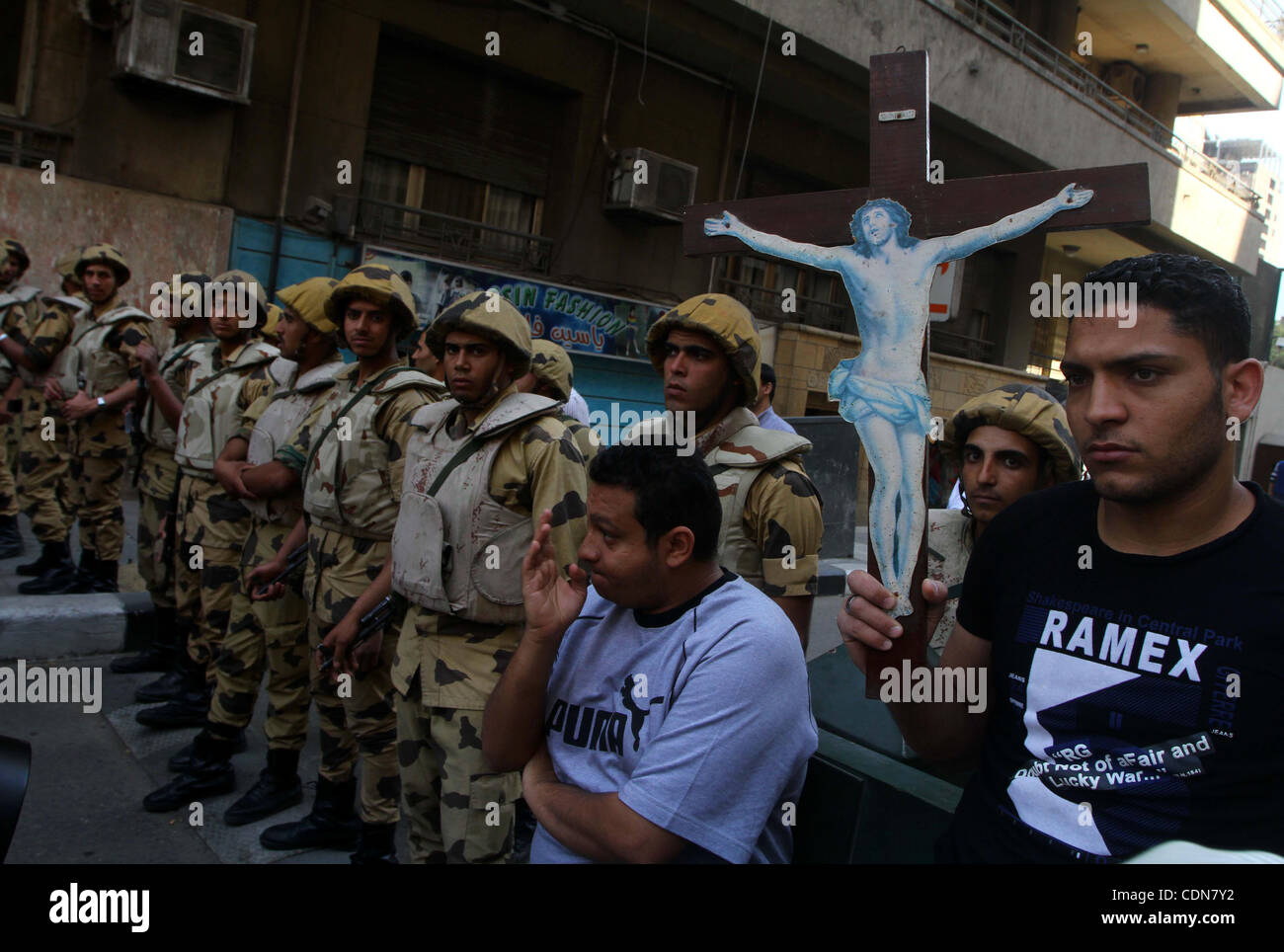 Egyptian soldiers stand guard as Coptic Christians take part in a ...