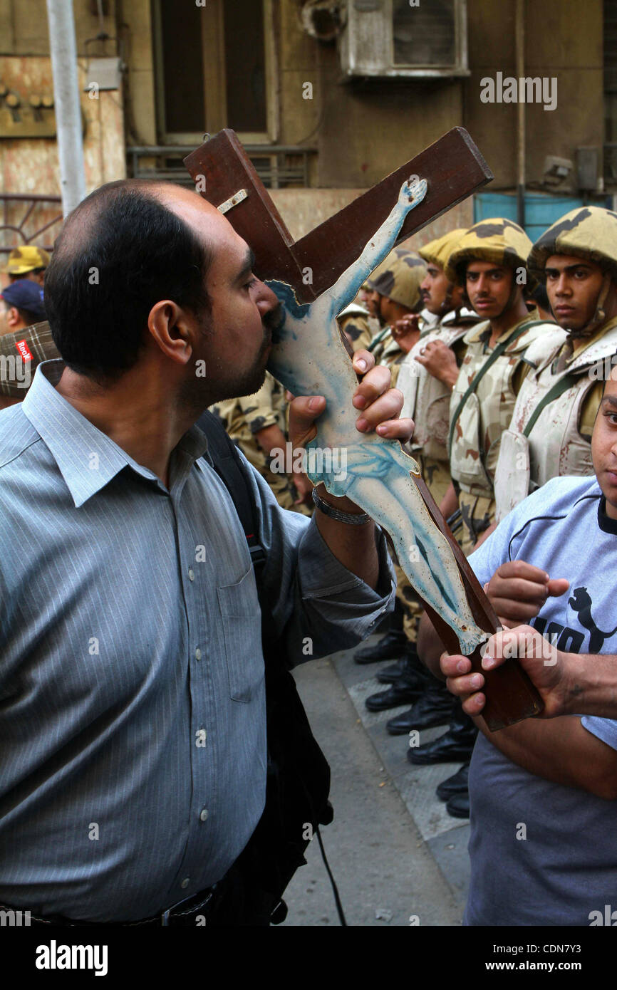 Egyptian soldiers stand guard as Coptic Christians take part in a ...