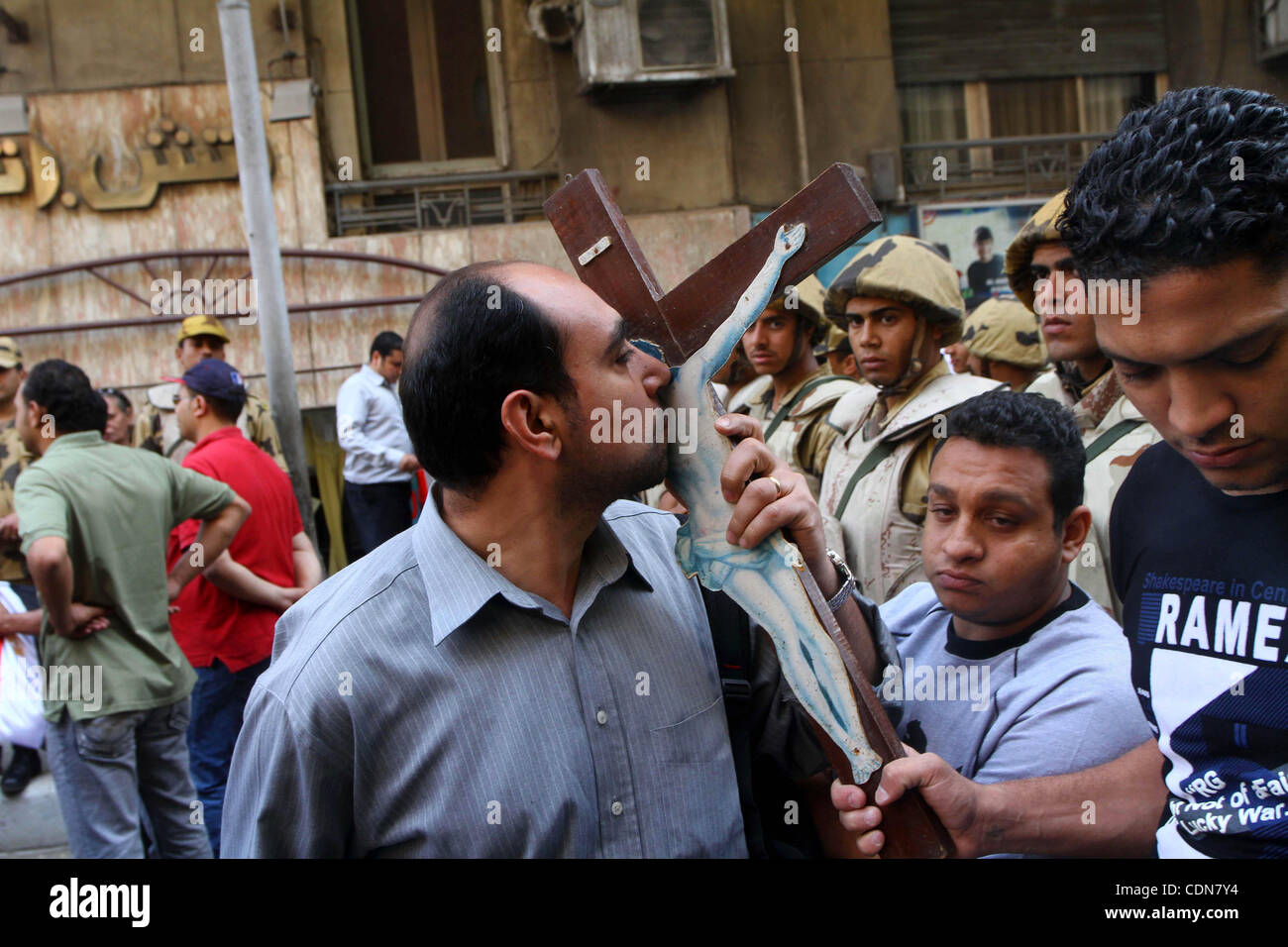 Egyptian soldiers stand guard as Coptic Christians take part in a ...