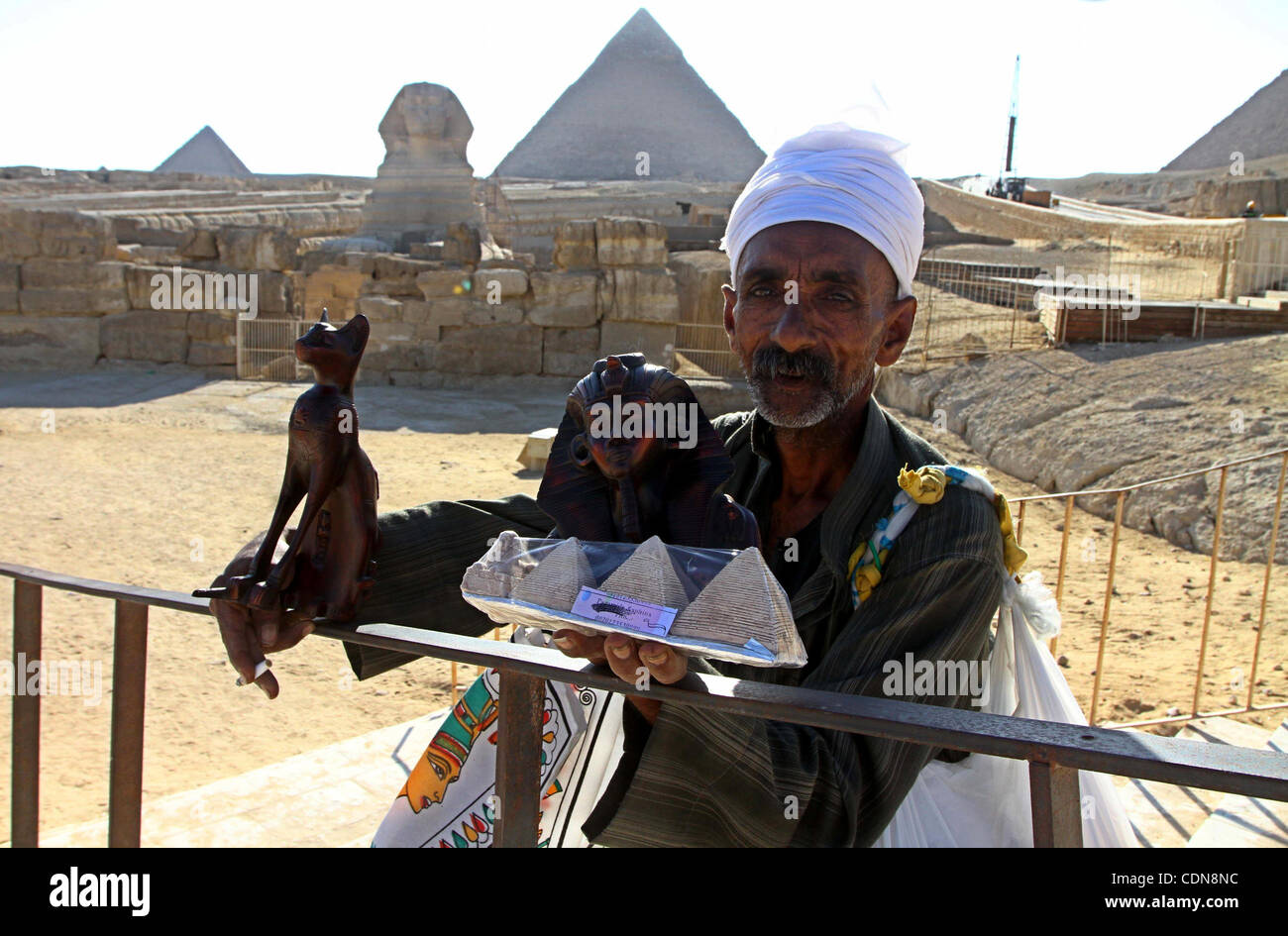 Egyptian man holds ancient relics of the Pharaonic civilization in near ...