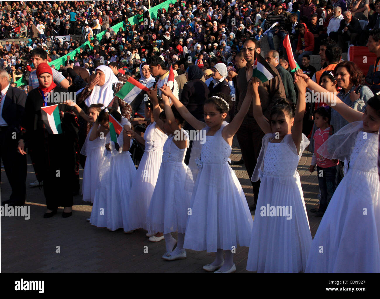 Palestinian brides and grooms take part in a mass wedding ceremony for ...
