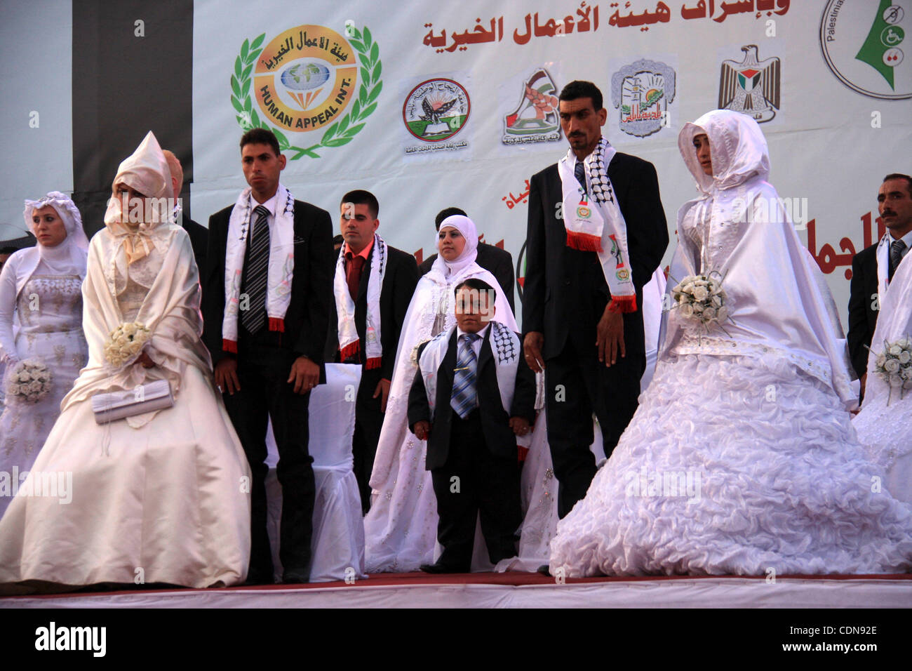 Palestinian brides and grooms take part in a mass wedding ceremony for ...