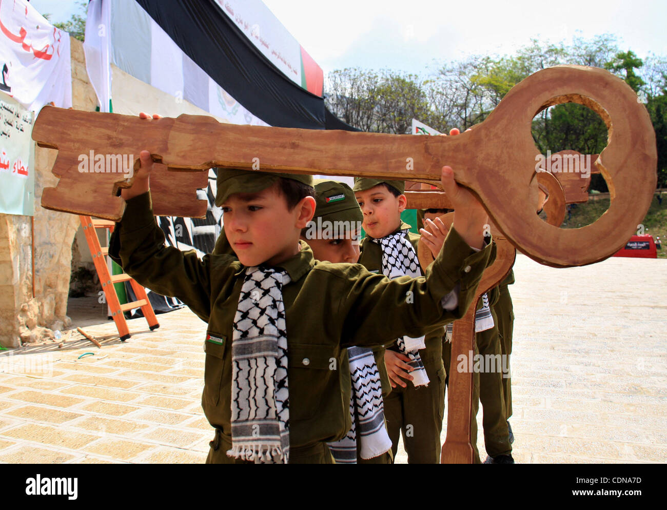 Palestinian children, some of them holding symbolic keys representing ...
