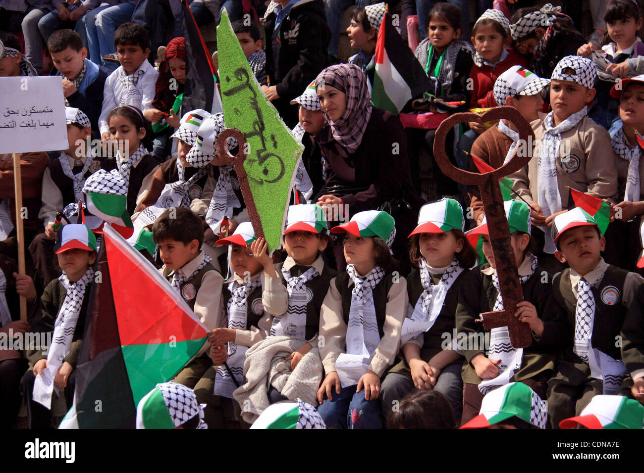 Palestinian children, some of them holding symbolic keys representing ...