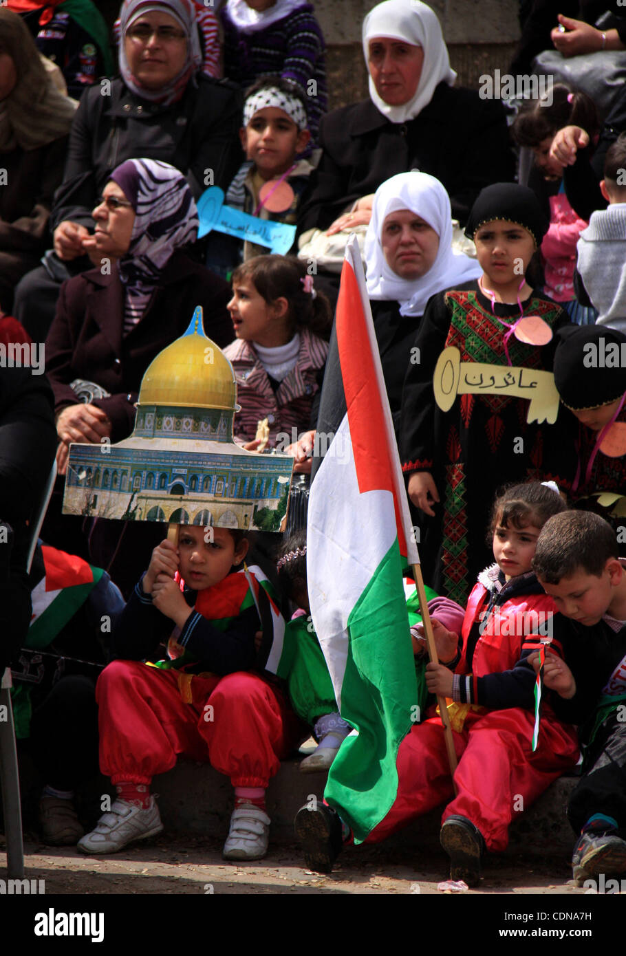 Palestinian children, some of them holding symbolic keys representing ...
