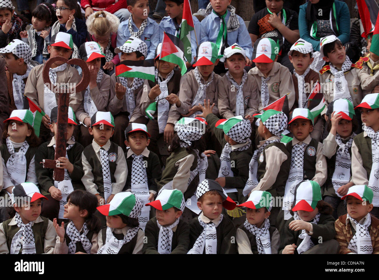 Palestinian children, some of them holding symbolic keys representing ...