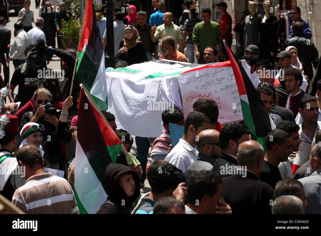 Palestinians in the West Bank city of Ramallah carry a mock coffin ...