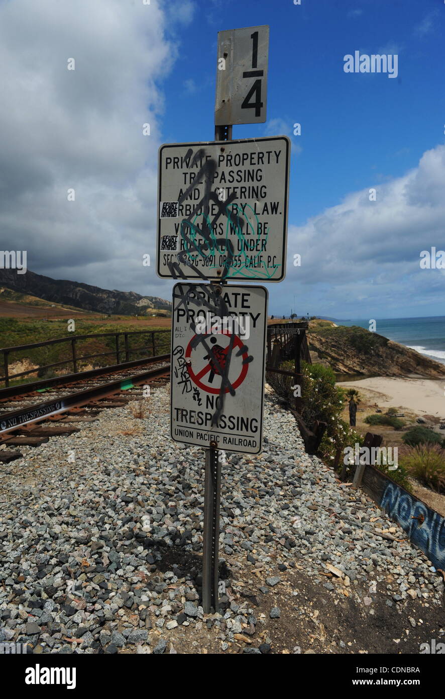 Graffiti defaces signs near the railroad train tracks high above ...