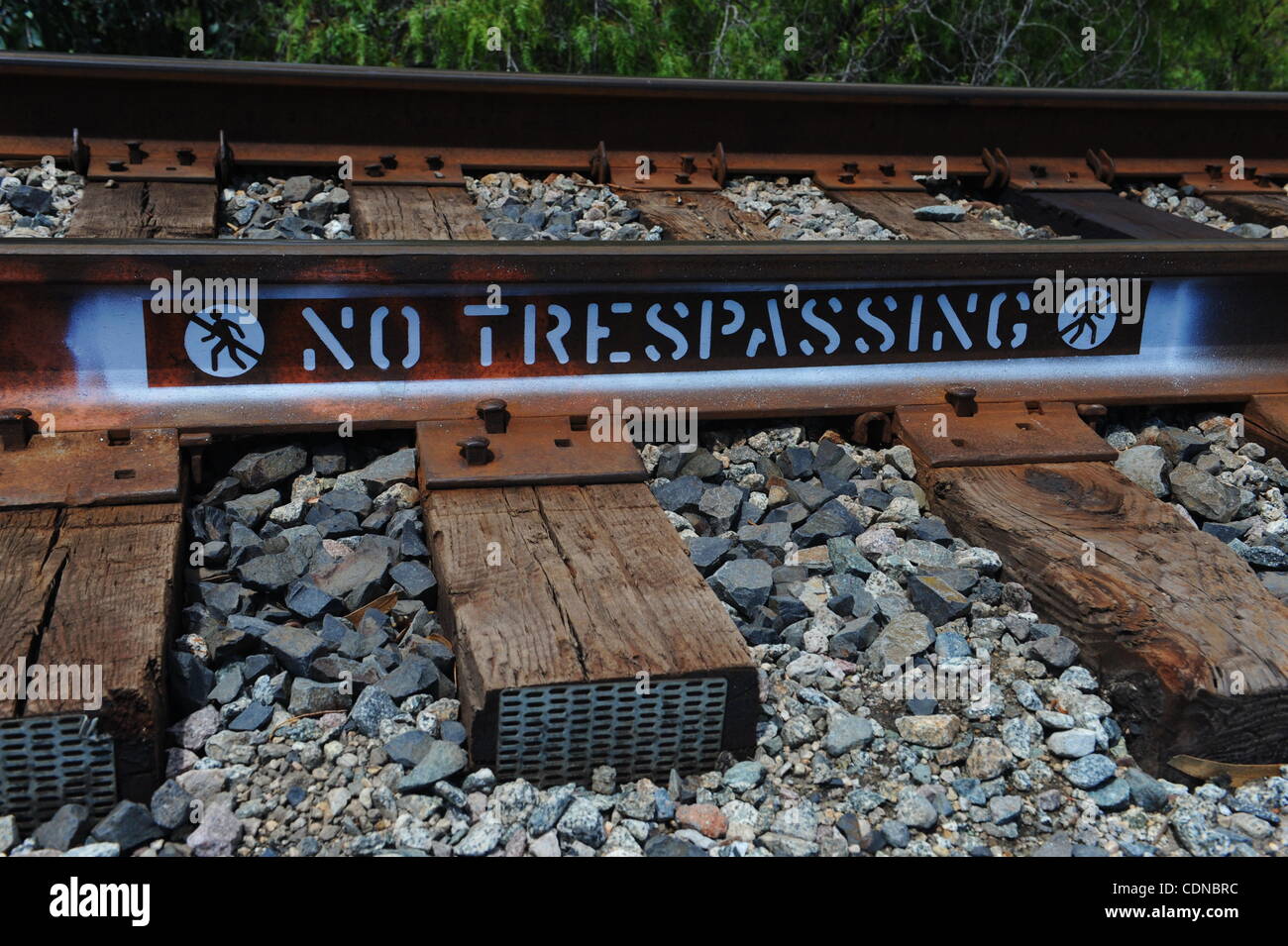 A no trespassing sign on the railroad train tracks high above Gaviota ...