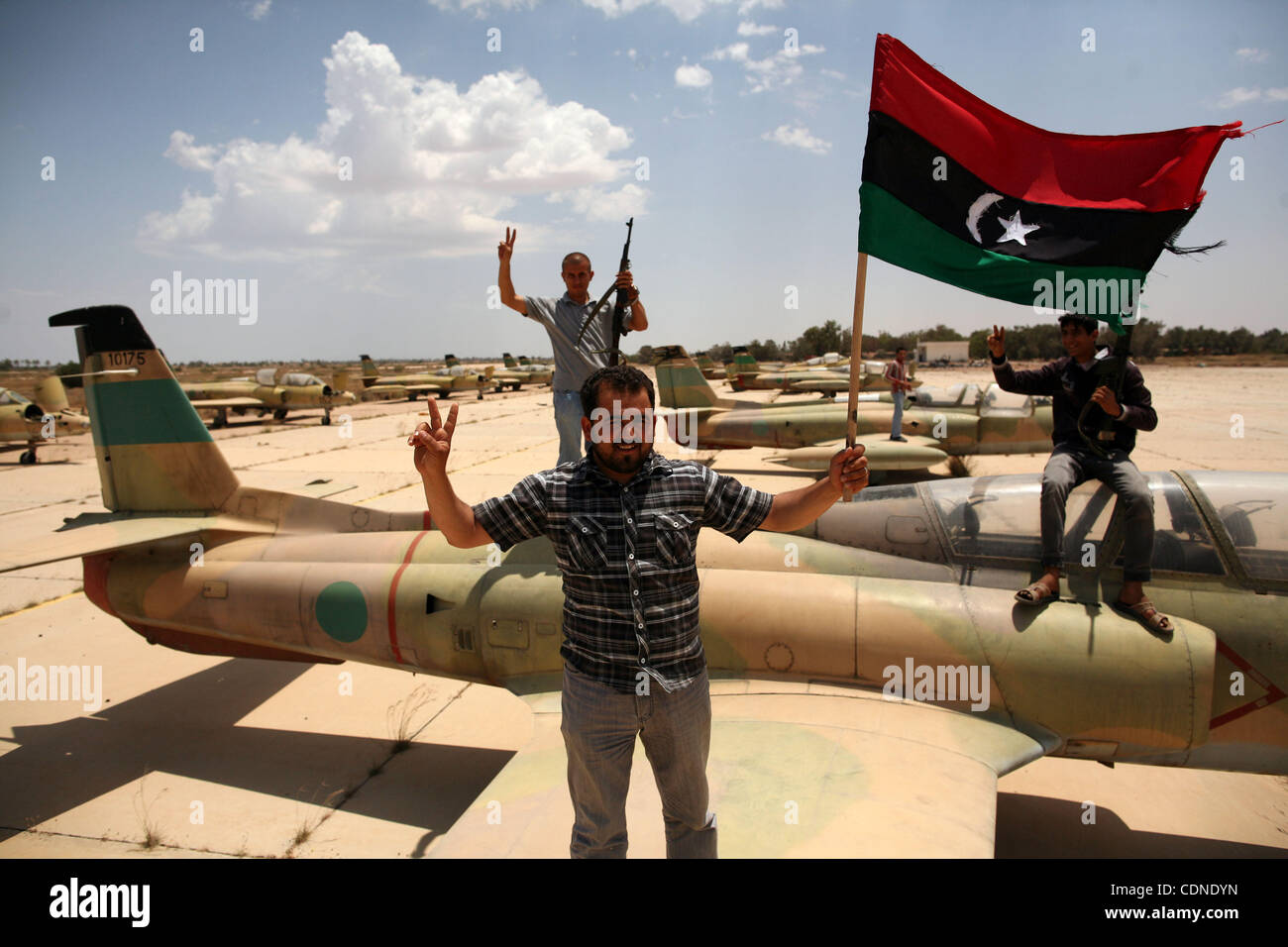 Libyan rebel fighters stand near fighter planes belonging to forces ...