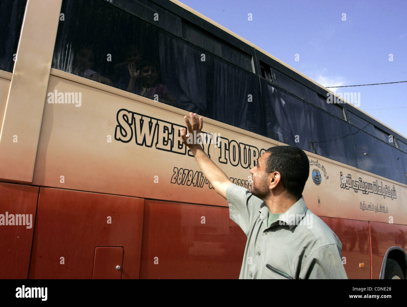 Palestinians sit in a bus as they wait to cross into Egypt through the ...
