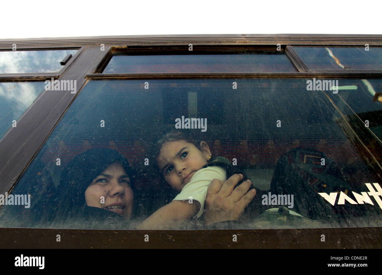 Palestinians sit in a bus as they wait to cross into Egypt through the ...