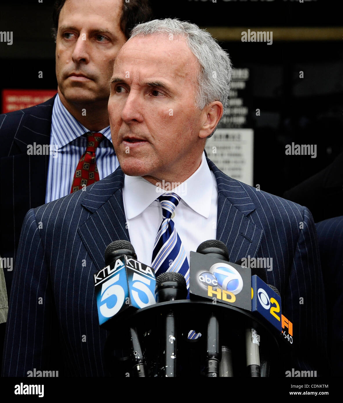 Frank McCourt talks to the media after a judge approved a settlement in ...