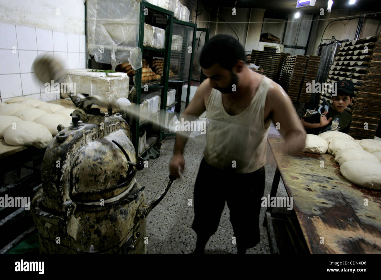 A Palestinian baker prepares bread at his bakery in Rafah, southern ...