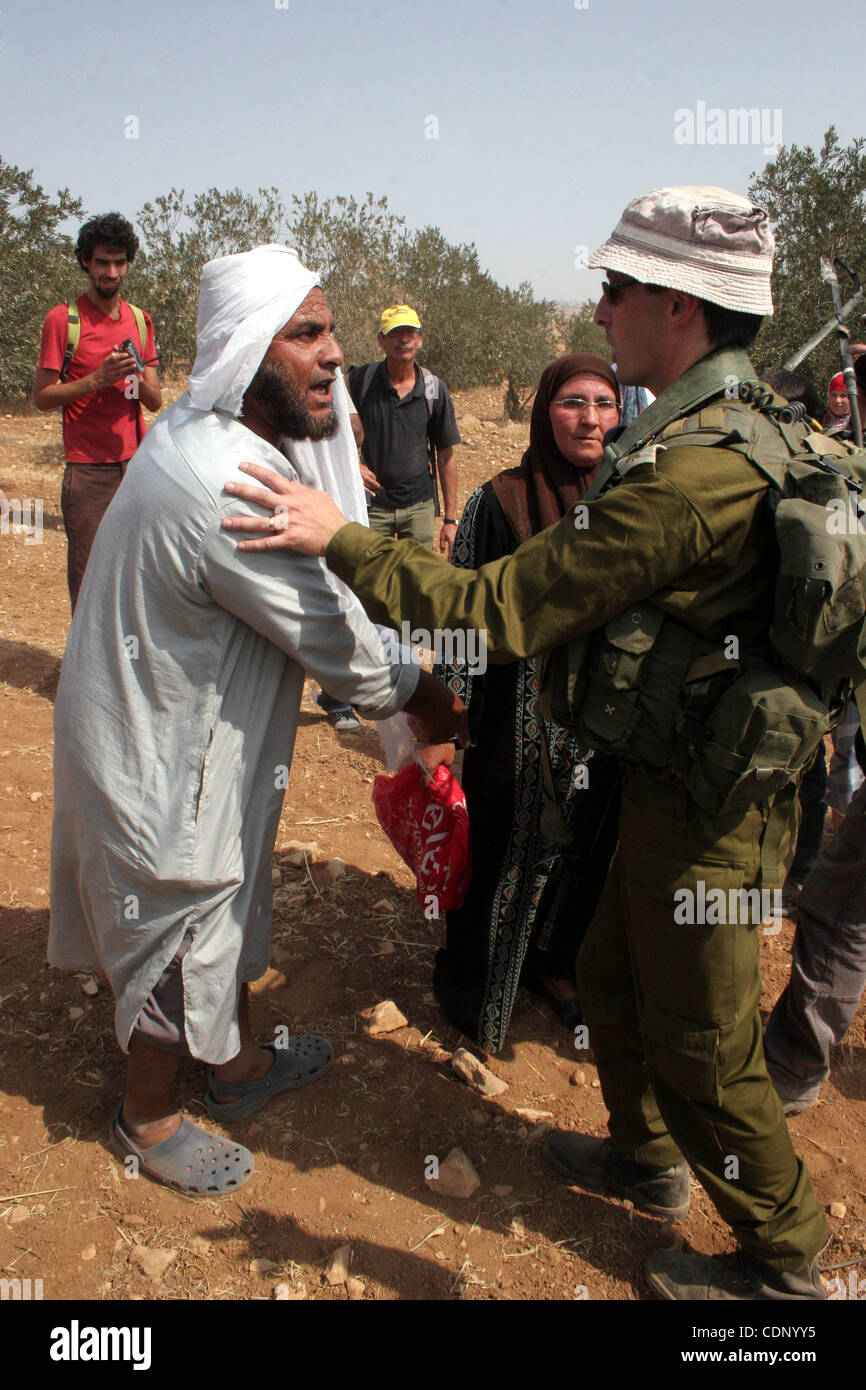 An Israeli soldier scuffles with Palestinian, foreign and Israeli ...