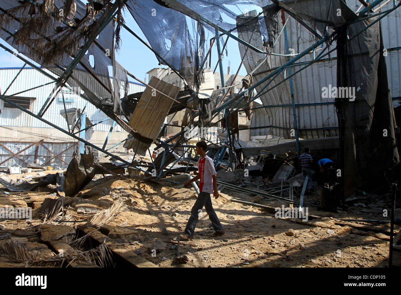 Palestinians inspect the site of an early morning Israeli airstrike in ...