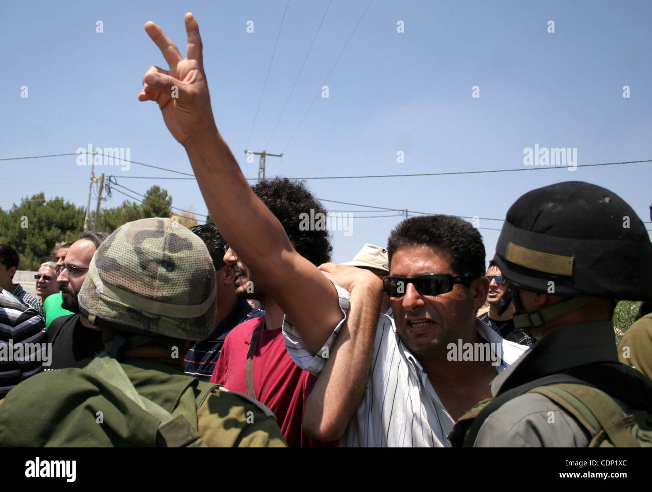 Protesters argue with an Israeli soldiers during a demonstration ...