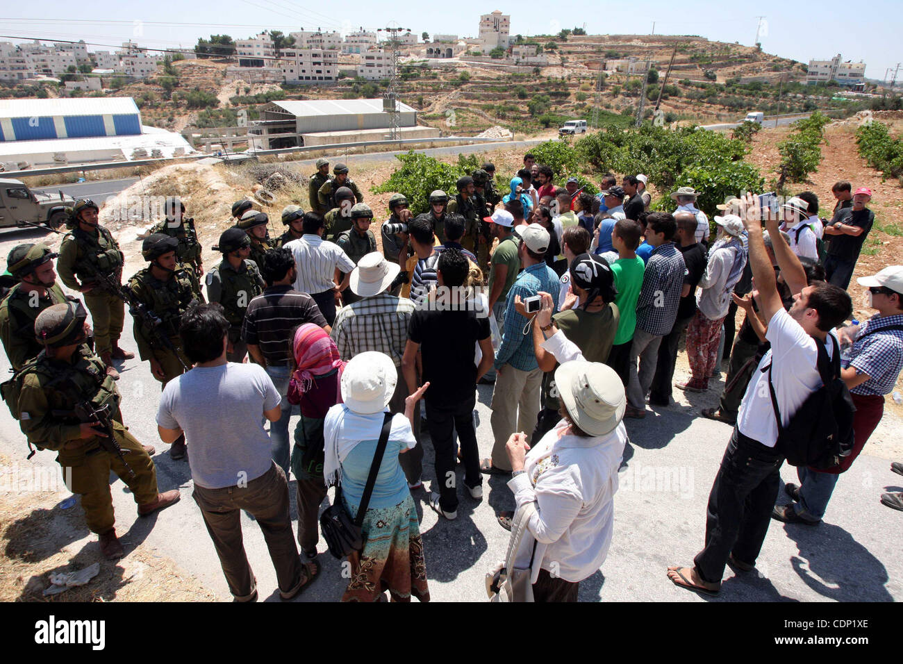 Protesters argue with an Israeli soldiers during a demonstration ...