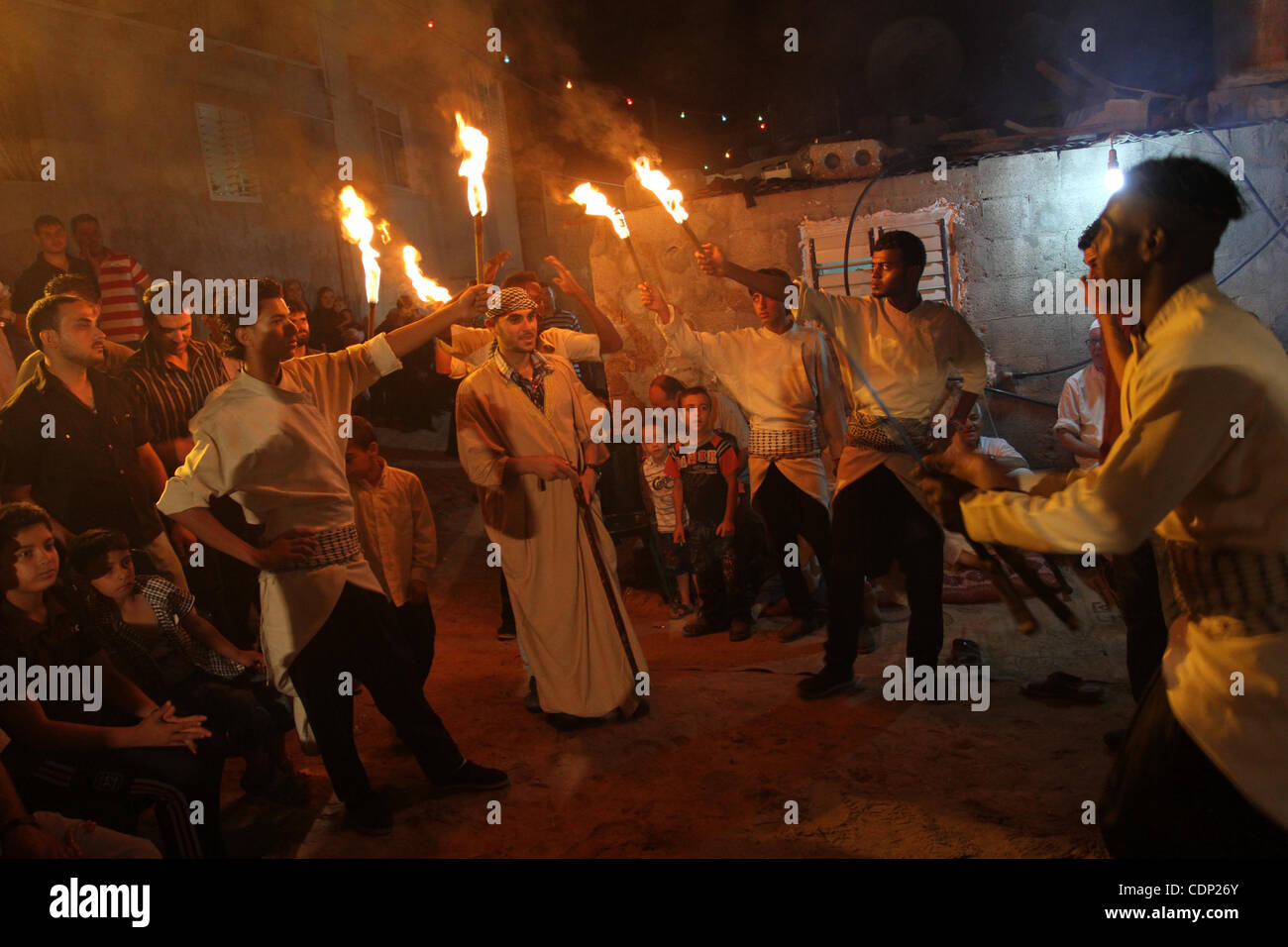 Palestinian youths dance the traditional dabka around the groom during ...