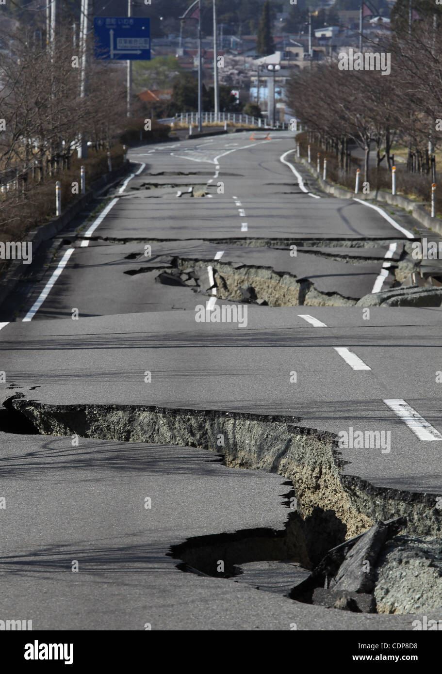 Apr. 16, 2011 - Futaba, Japan - A street lies buckled and broken by the ...