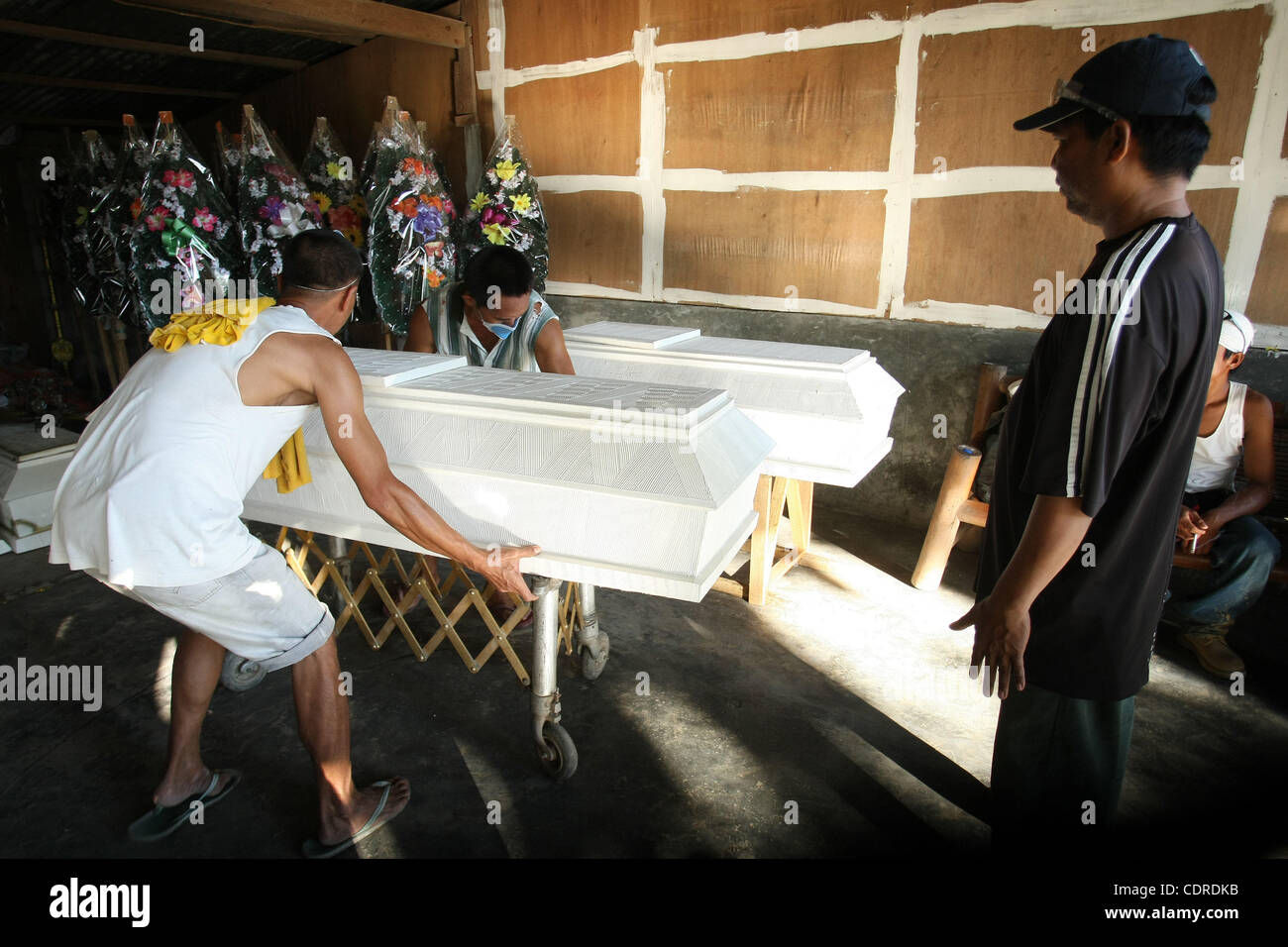 Apr. 24, 2011 - Pantukan, Philippines - Funeral parlor workers arrange ...