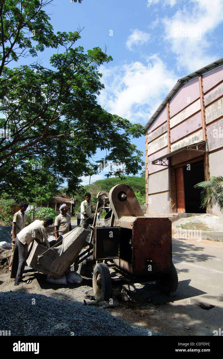 Construction workers toil in the heat outside of a studio on the edge ...