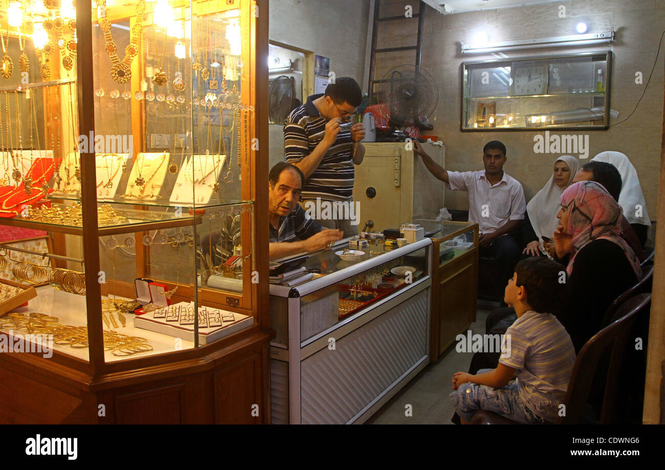 Palestinians look at gold jewellery at a jewellery store in Gaza city ...
