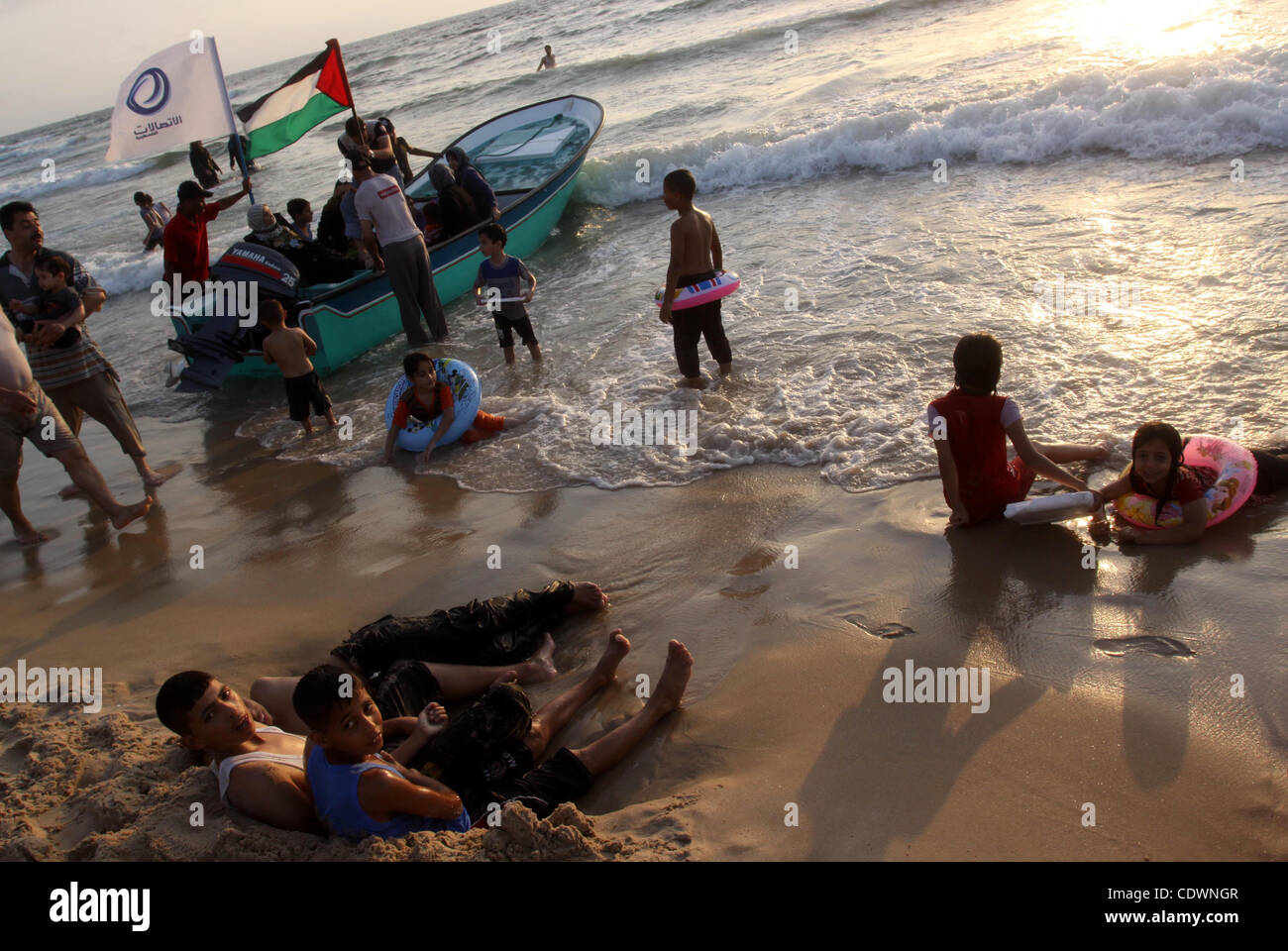 Palestinians cool off on the beach in Gaza City Friday, July 22, 2011 ...