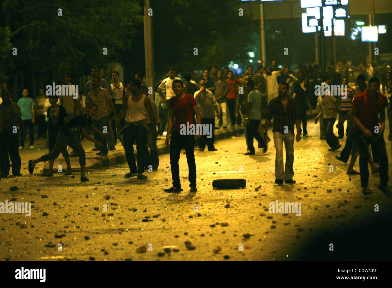 Demonstrators throw rocks during clashes with loyalists of the ruling ...