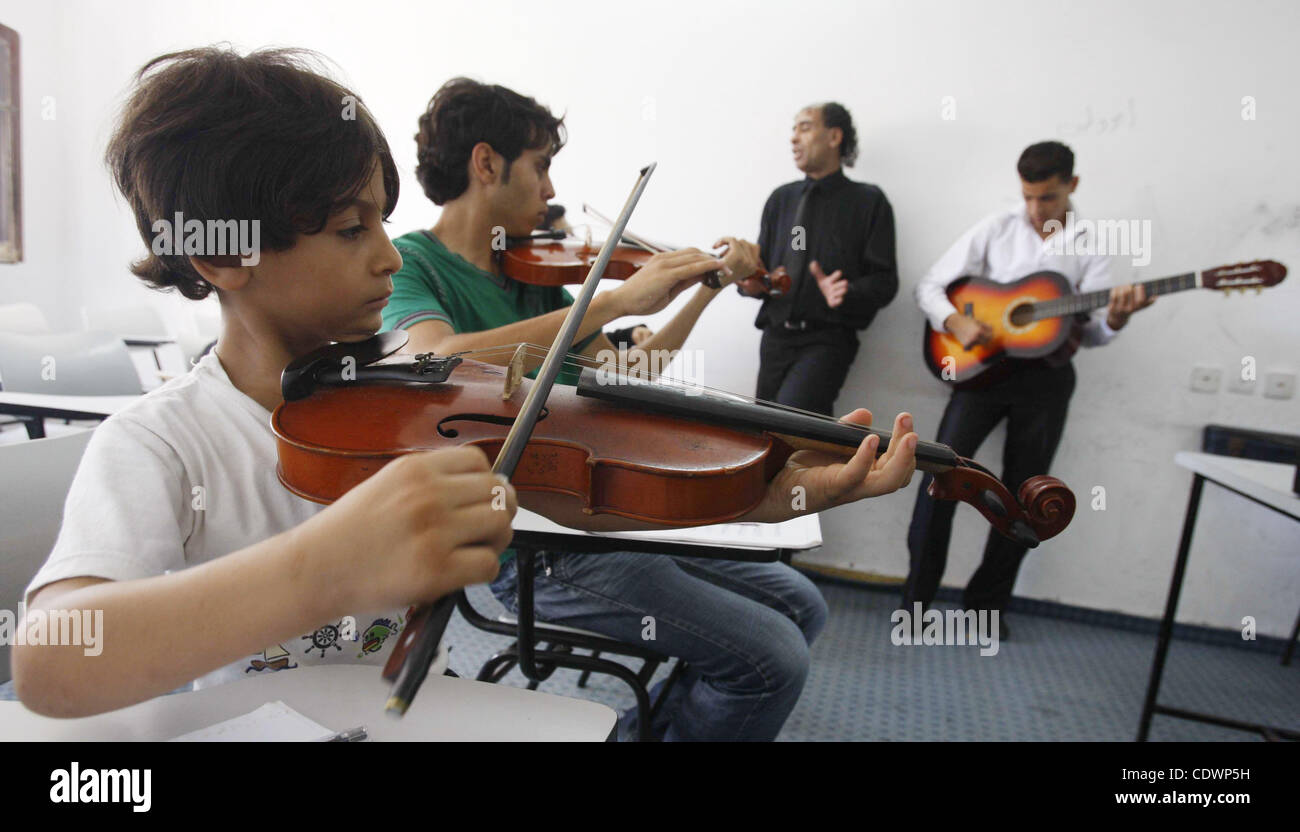 A Palestinian boy plays on musical instruments at the Gaza College in ...