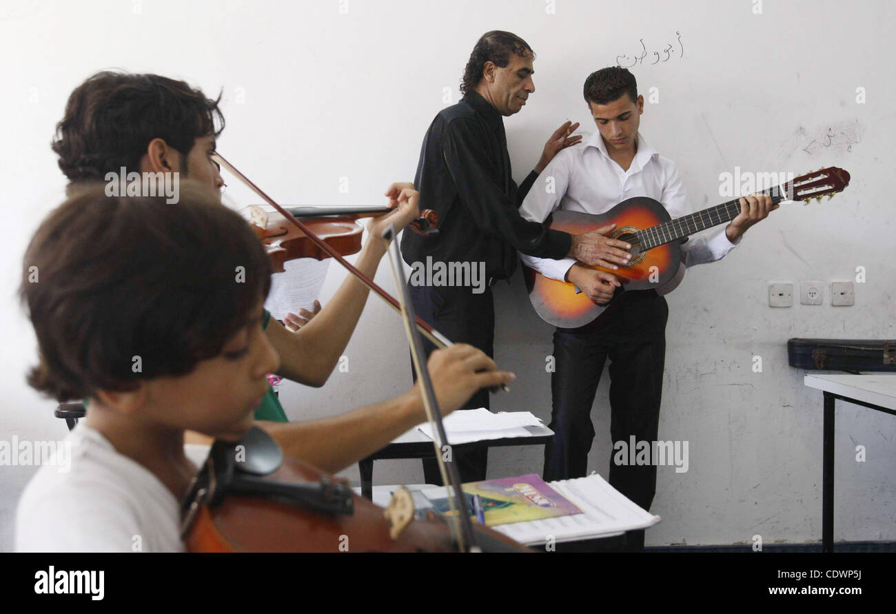A Palestinian boy plays on musical instruments at the Gaza College in ...