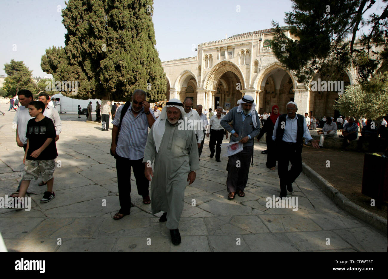 Palestinians are walk at the entrance of the Al-Aqsa mosque compound ...
