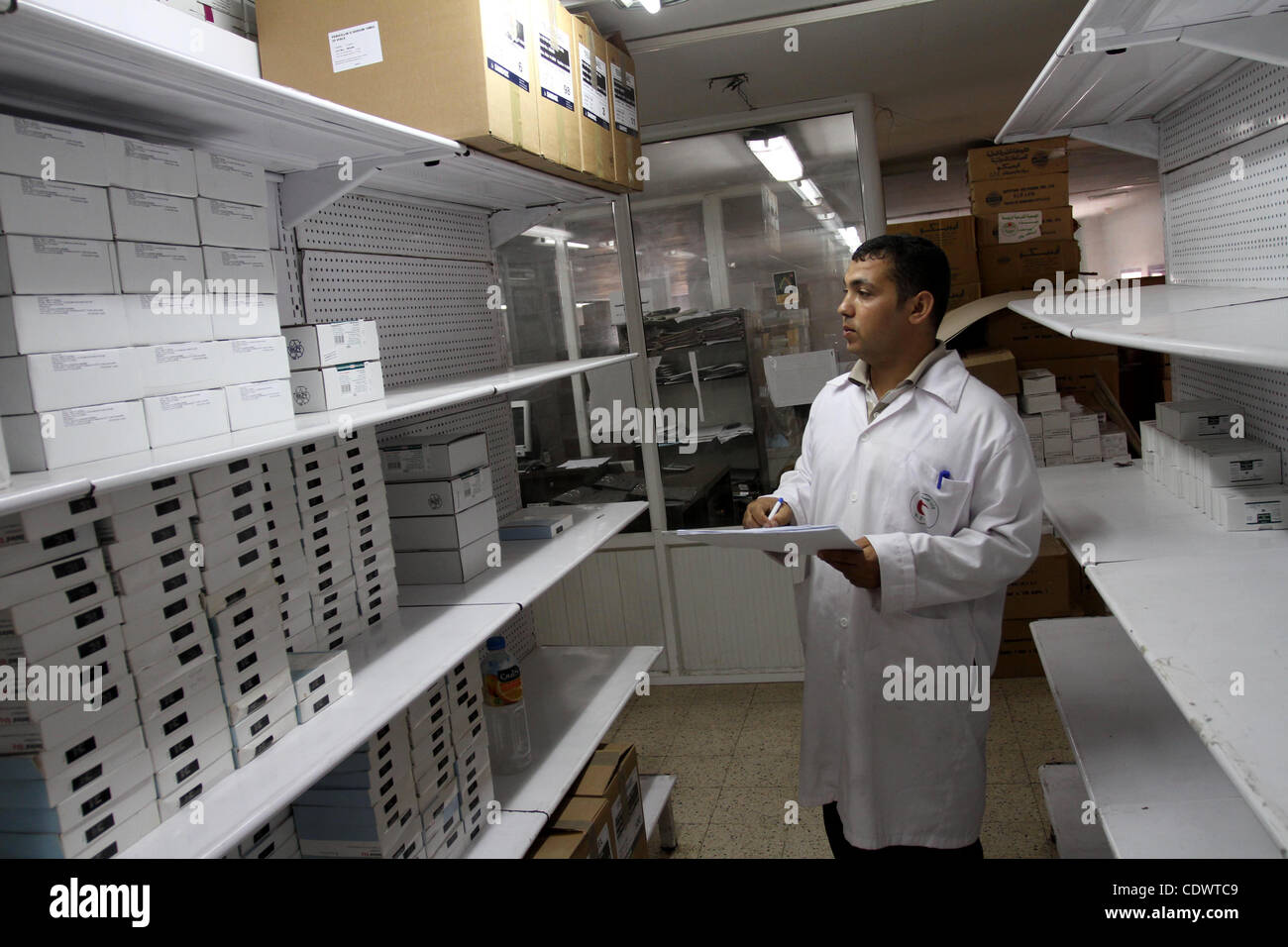 A Palestinian doctor check out medicines at the medical stores where ...