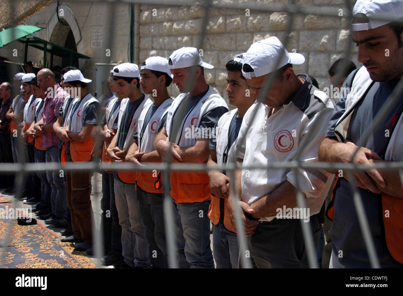 Palestinian Muslims pray at the entrance to the Ibrahimi Mosque, in the ...