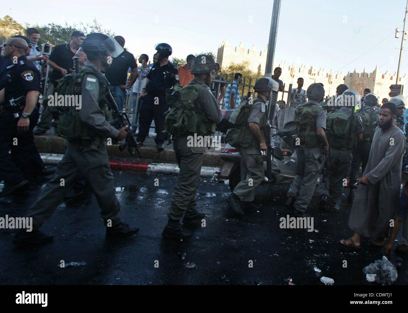 Israeli border guard keep watch Palestinians as they shop at a market ...