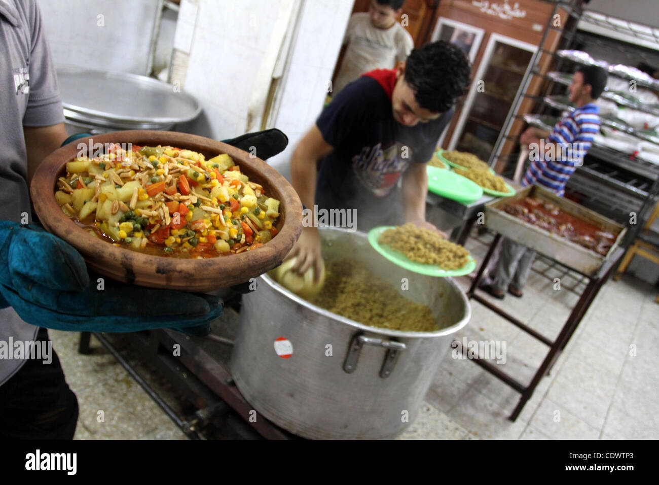 Palestinian bakers prepare rice and meat 'Qedrah" in a traditional ...
