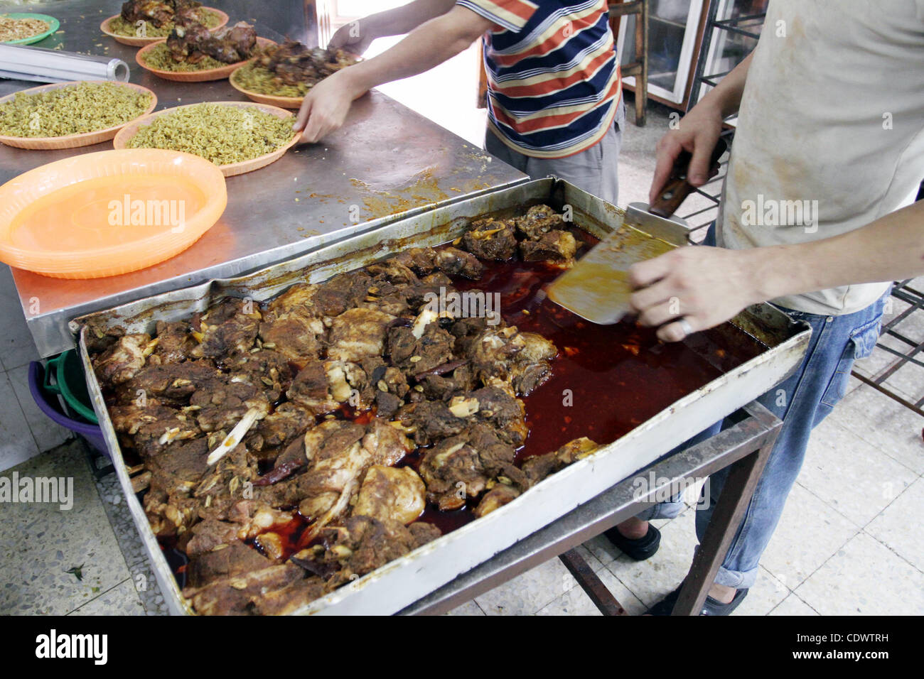 Palestinian bakers prepare rice and meat 'Qedrah" in a traditional ...