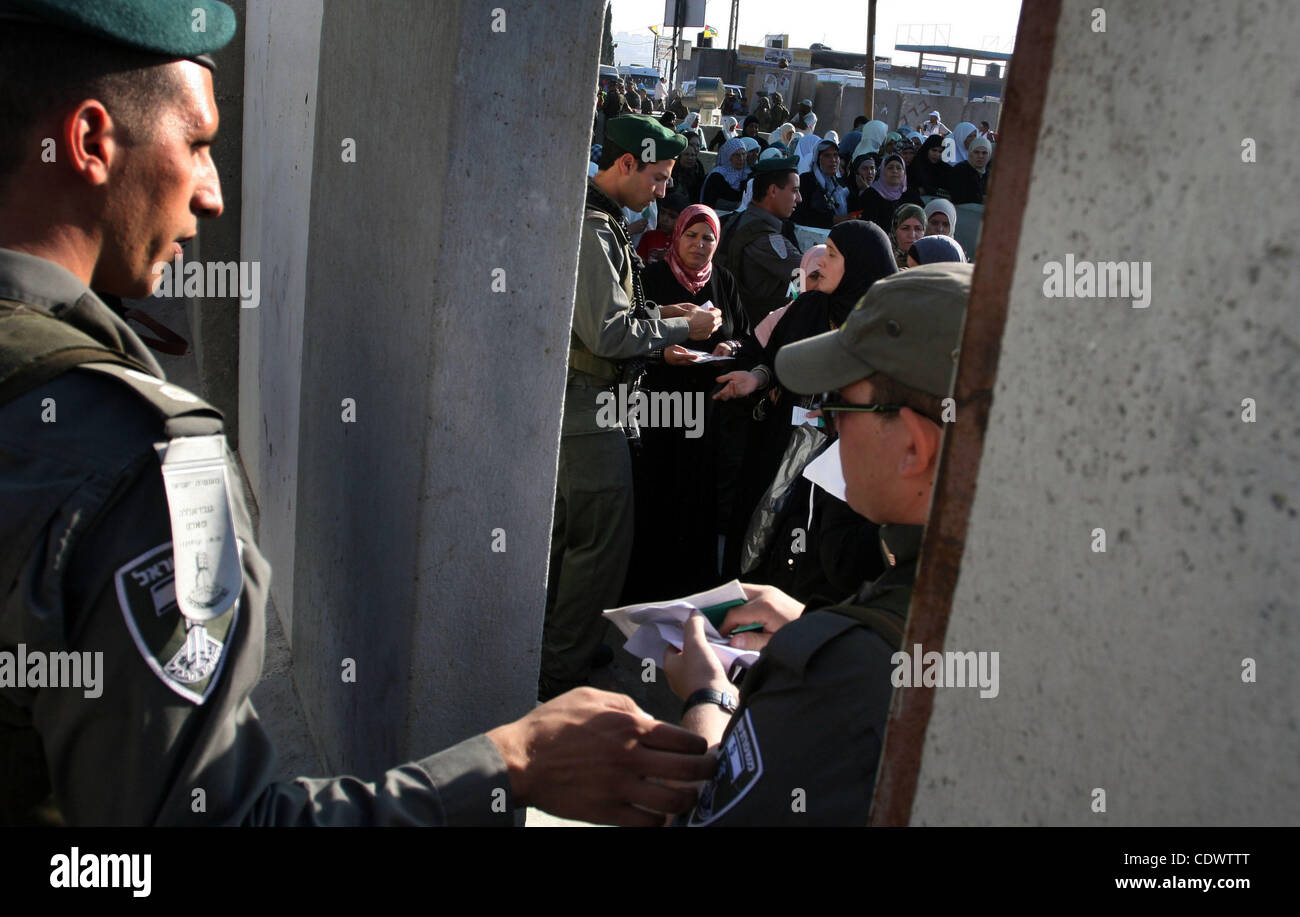 Palestinian women wait in line to pass through the Kalandia checkpoint ...