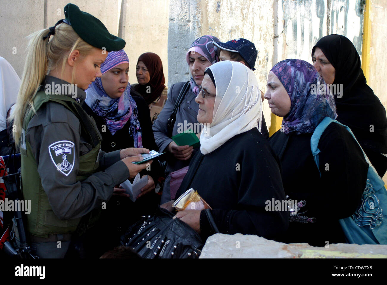 Palestinian Muslims walk through an Israeli checkpoint on the outskirts ...