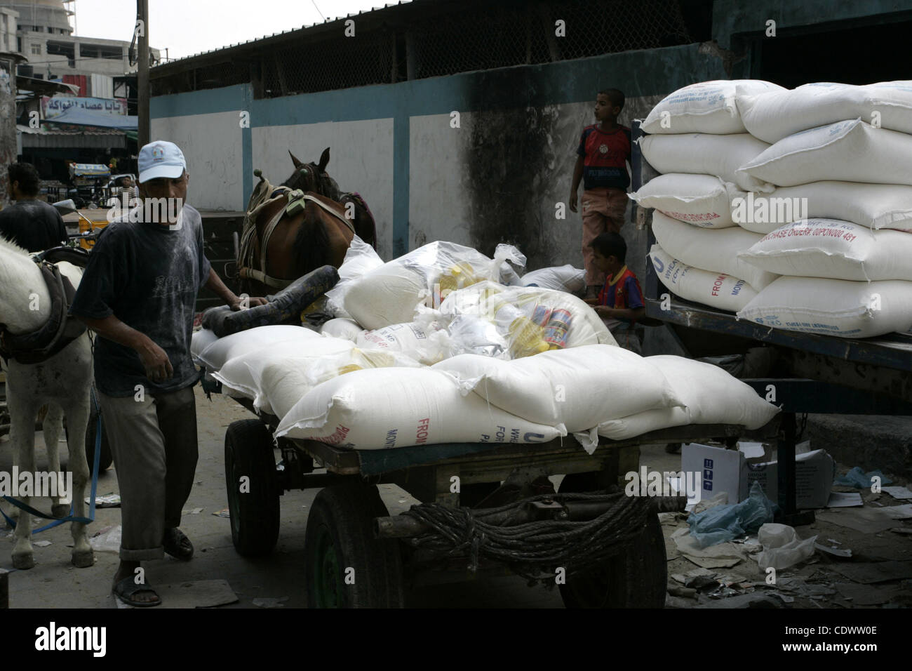 Palestinians receive food aids from the United Nations Relief and Works ...